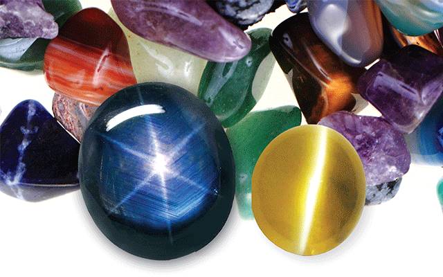 L to R: Blue sapphire with asterism; yellow topaz with chatoyancy ...